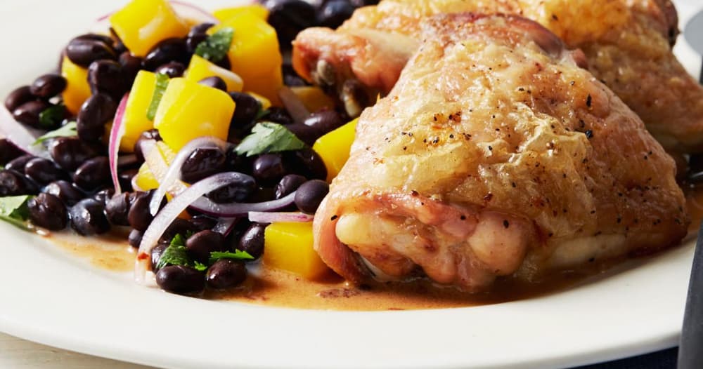 Crispy Roasted Chicken Thighs with Chipotle-Coconut Sauce and Black Bean-Mango Salad | Punchfork